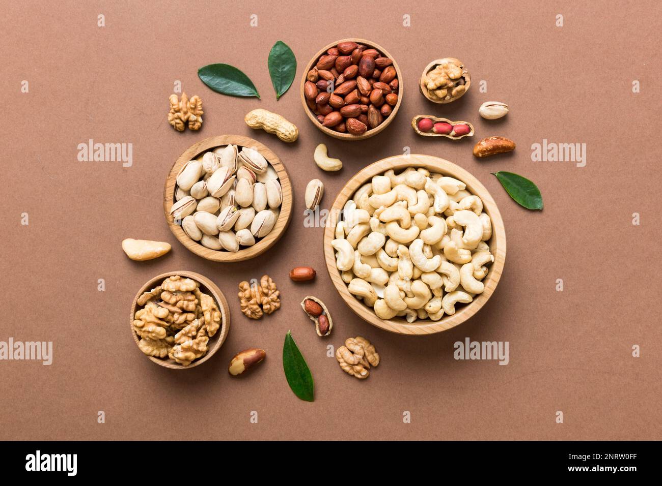mixed nuts in wooden bowl. Mix of various nuts on colored background ...