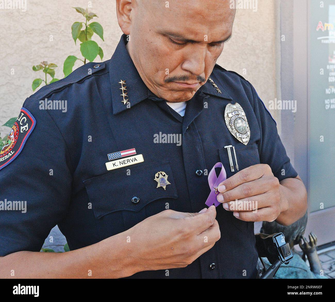 Quechan Tribal Police Department Chief Kirk Nerva attaches his purple ...
