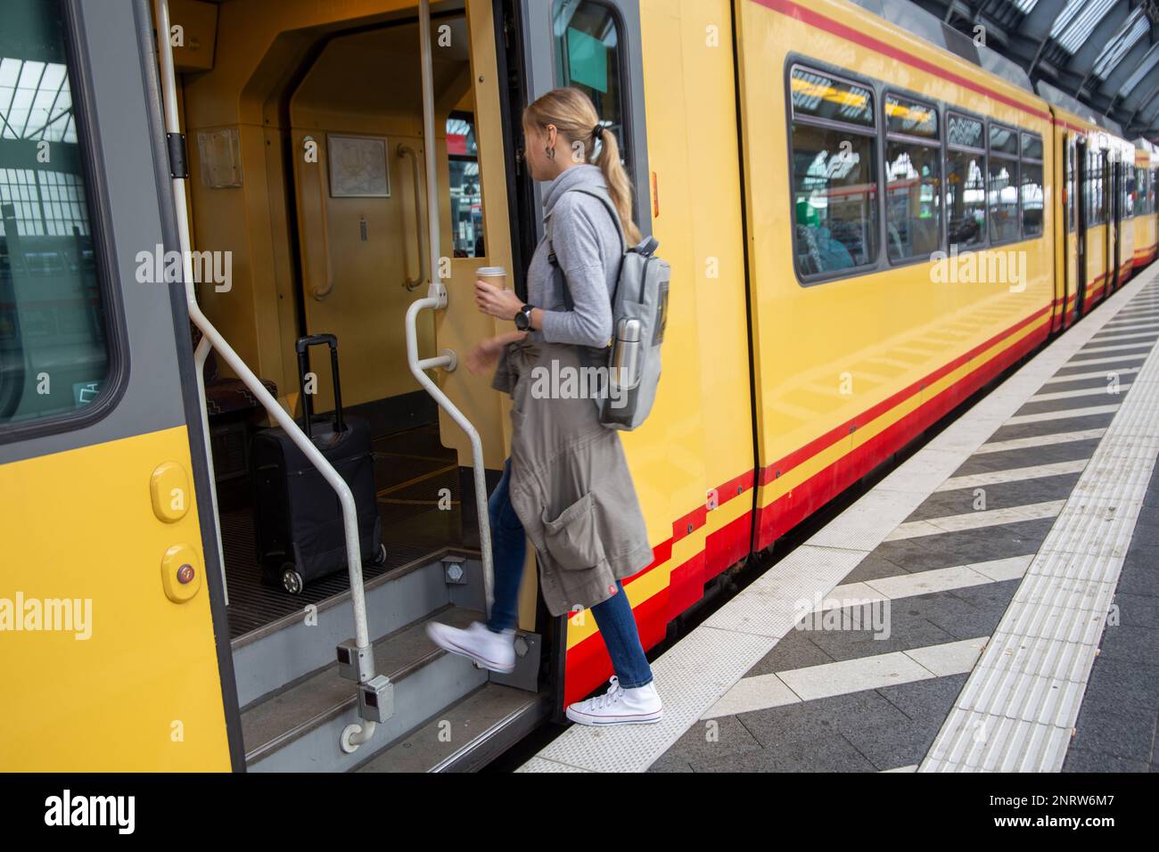 Young woman getting on a train (Model released Stock Photo - Alamy