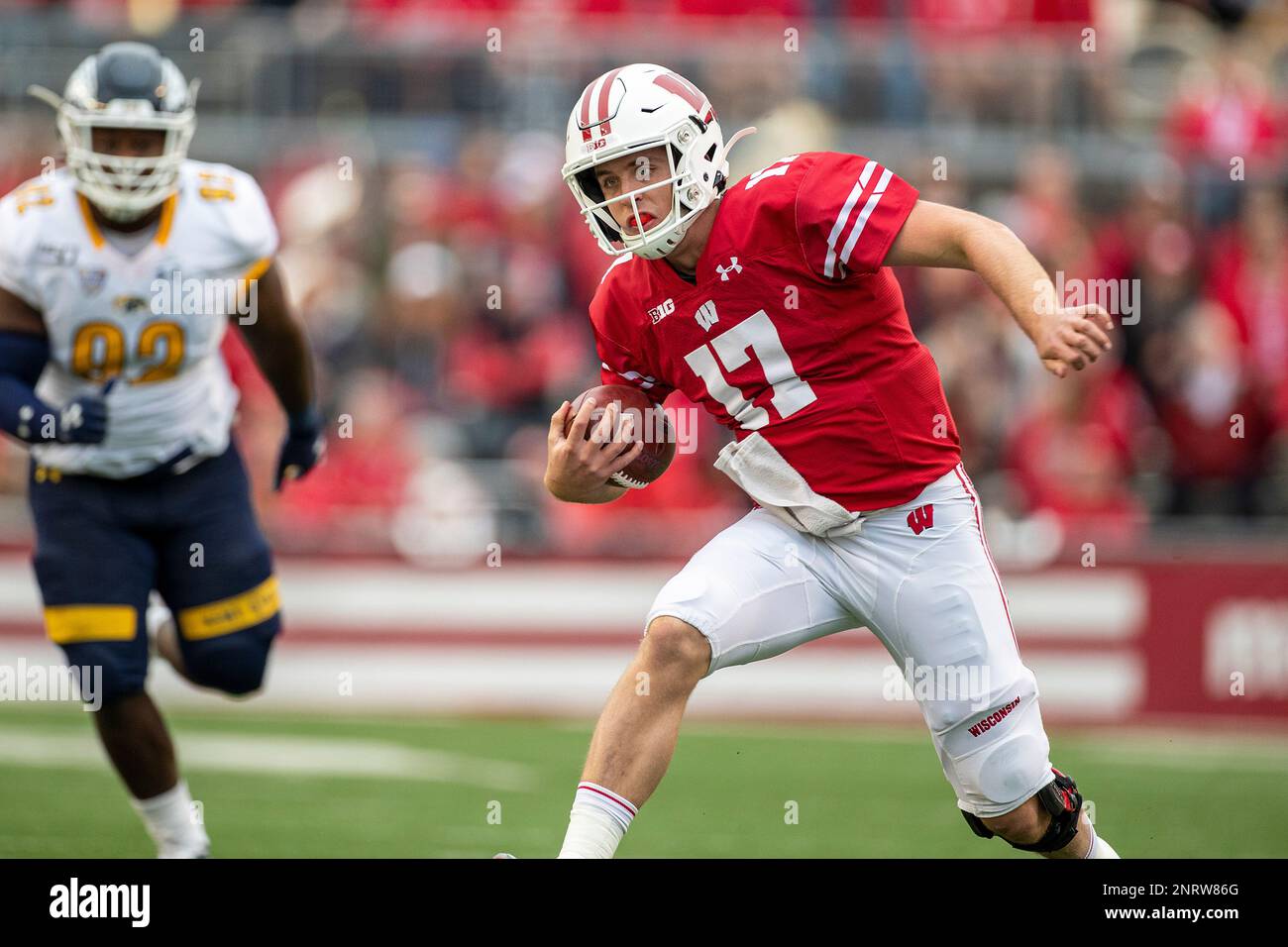 Wisconsin Badgers quarterback Jack Coan (17) scrambles for yardage ...