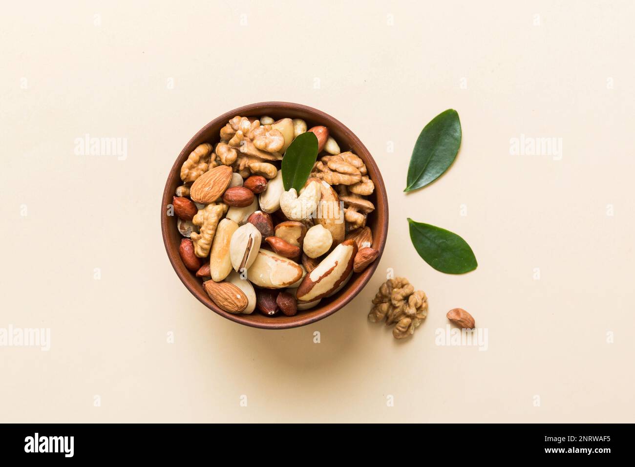mixed nuts in bowl. Mix of various nuts on colored background ...