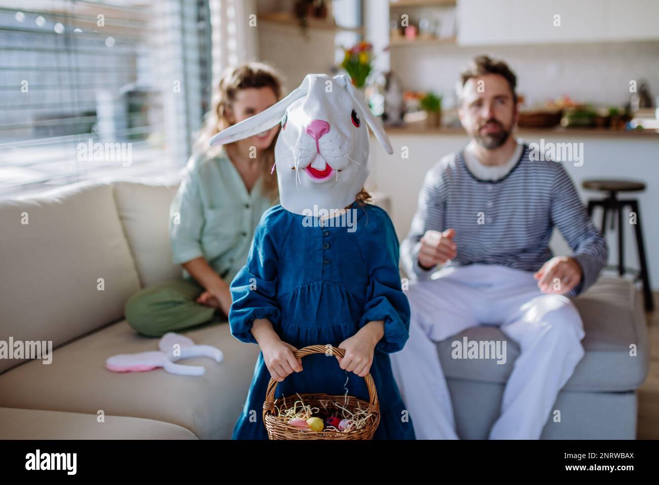 Little girl with rabbit mask celebrating spring with her parents Stock ...