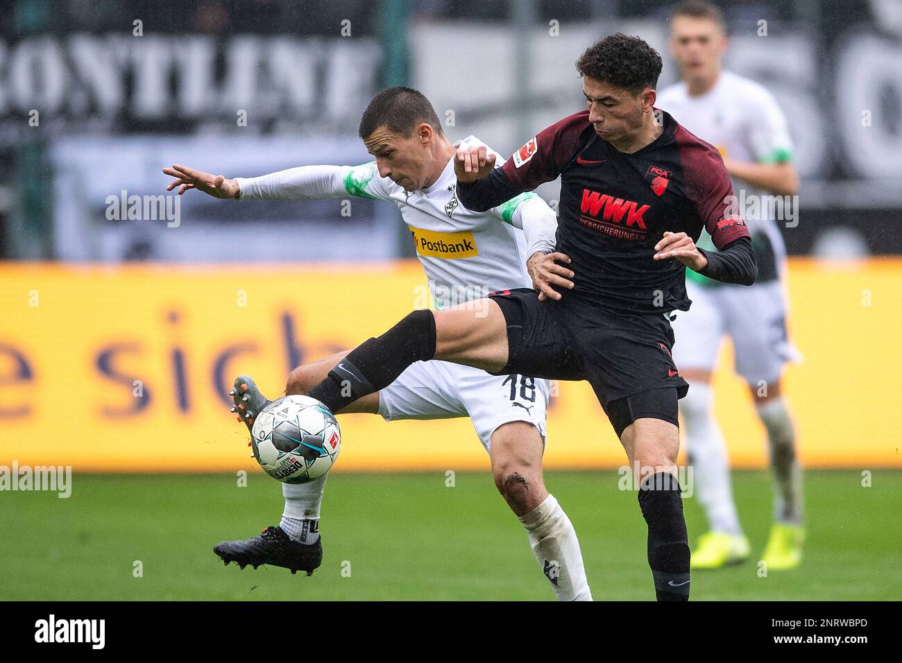Gladbach's Stefan Lainer, left, and Augsburg's Ruben Vargas, right ...