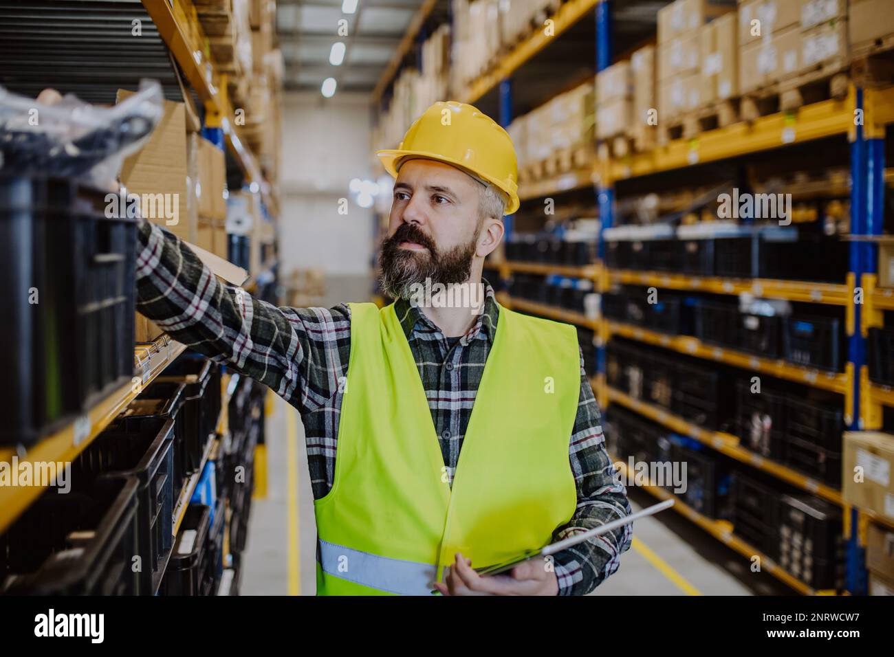 Warehouse worker checking up stuff in a warehouse Stock Photo - Alamy