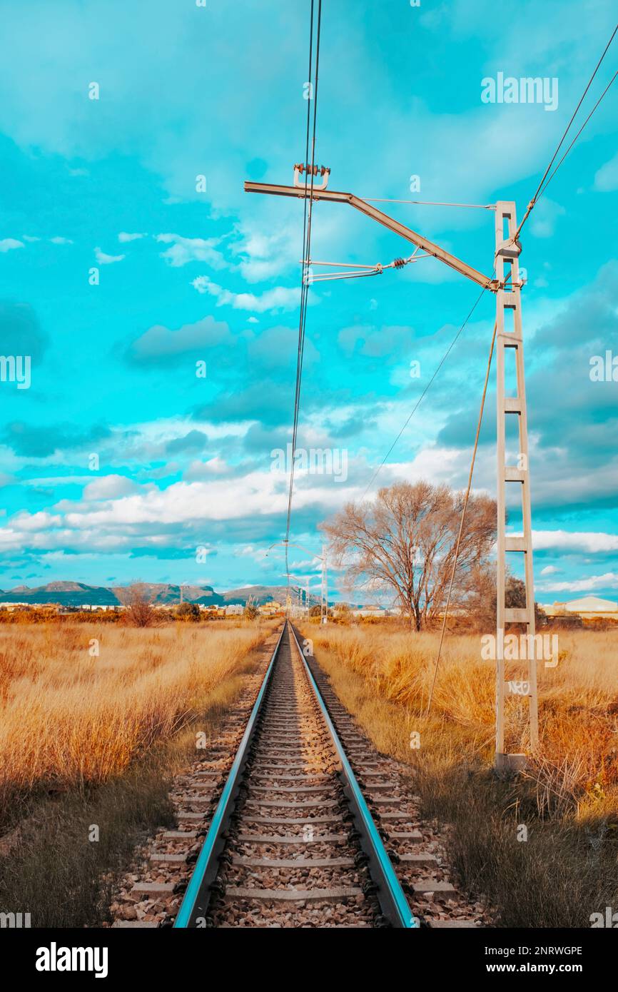 Empty railway in country side against a blue sky with clouds. Concept ...