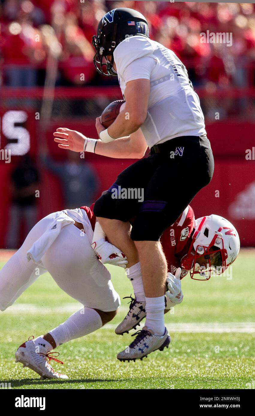 Northwestern quarterback Aidan Smith, top, gets hit by Nebraska's ...