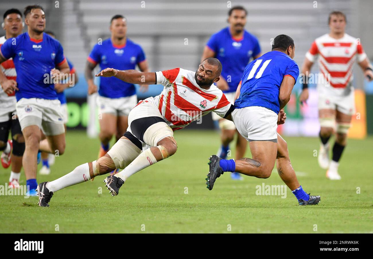 Japan's Michael Leitch attempts a tackle on Samoa's Ed Fidow, right ...