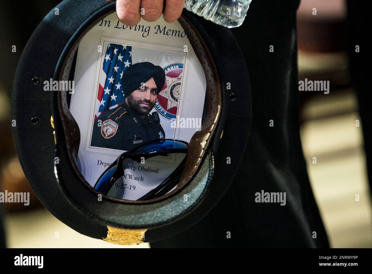 A Houston Police officer places a picture of Harris County Sheriff's ...