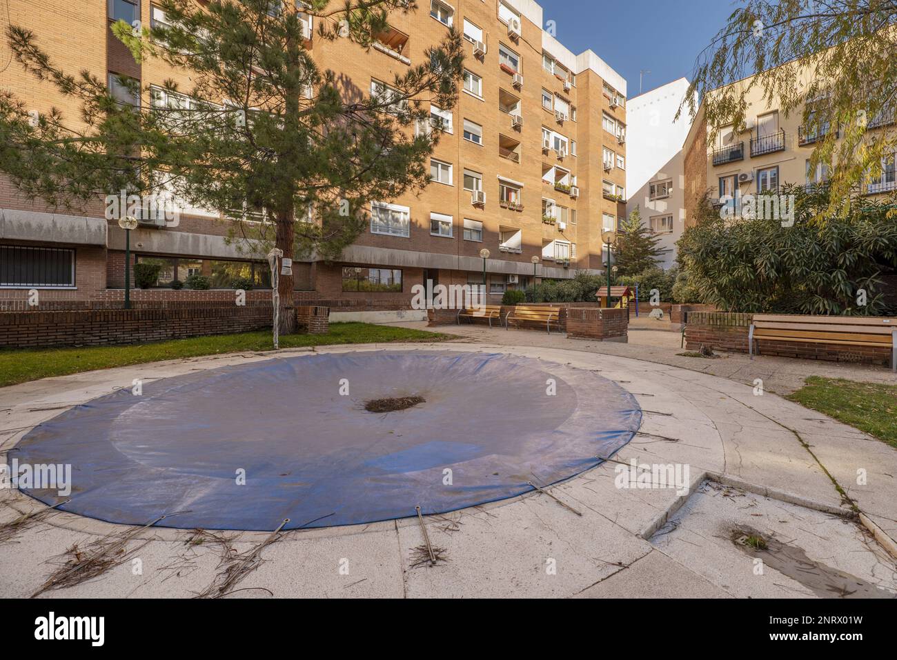 A circular summer pool covered with canvas to spend the winter in the ...