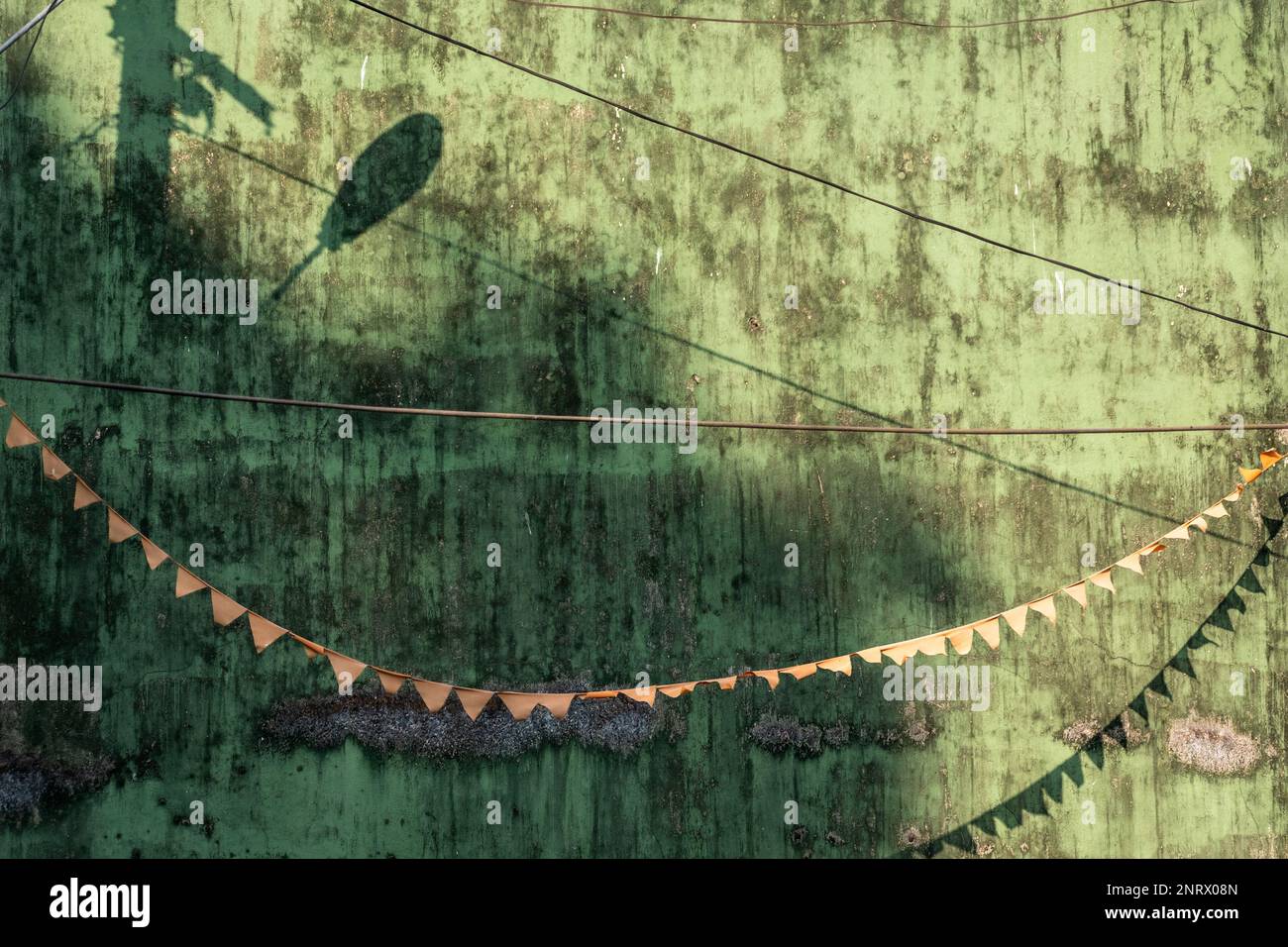 Abstract background with a line of saffron flags with a grungy green ...