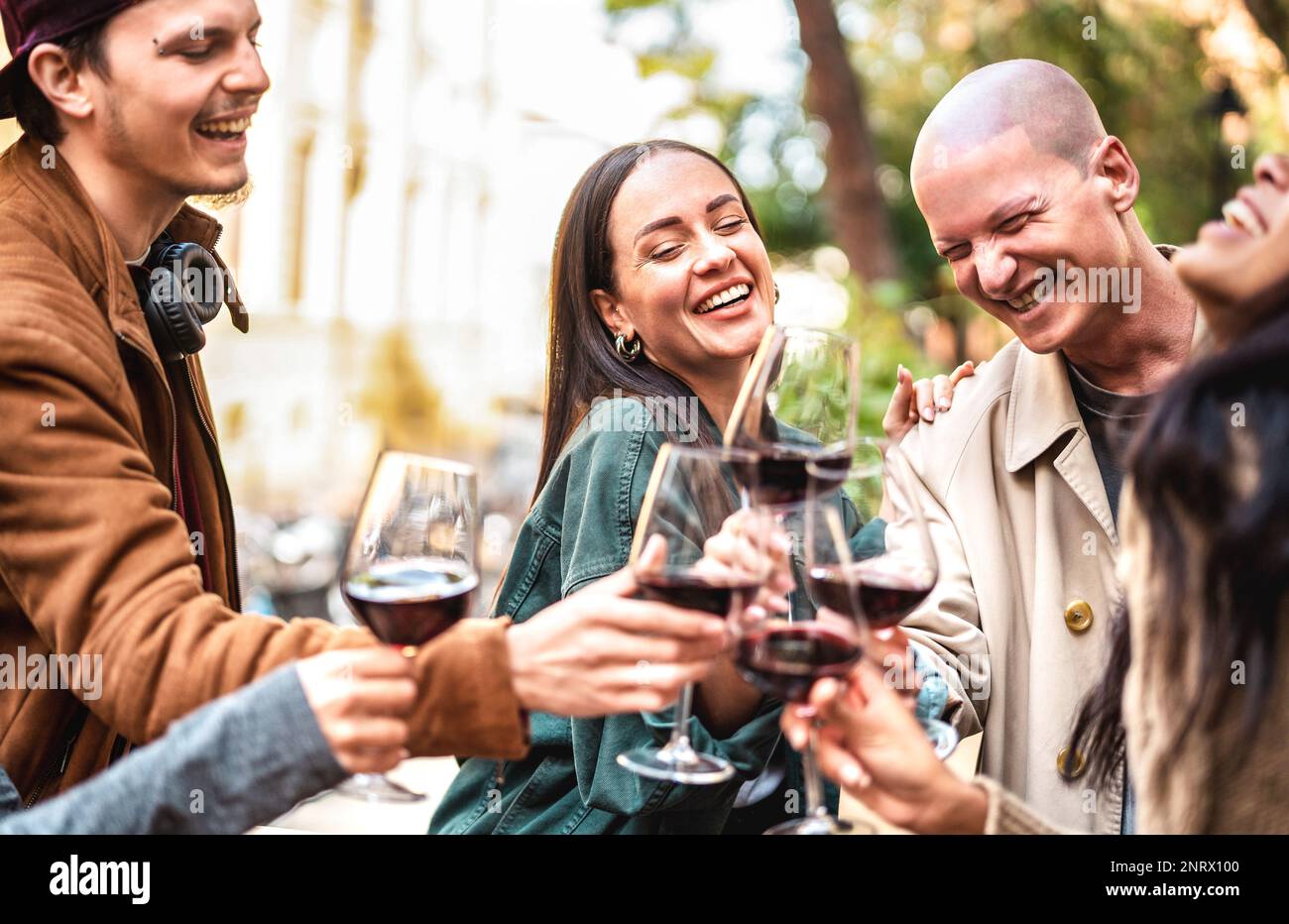 Trendy people having fun drinking red wine out side at city winery bar ...