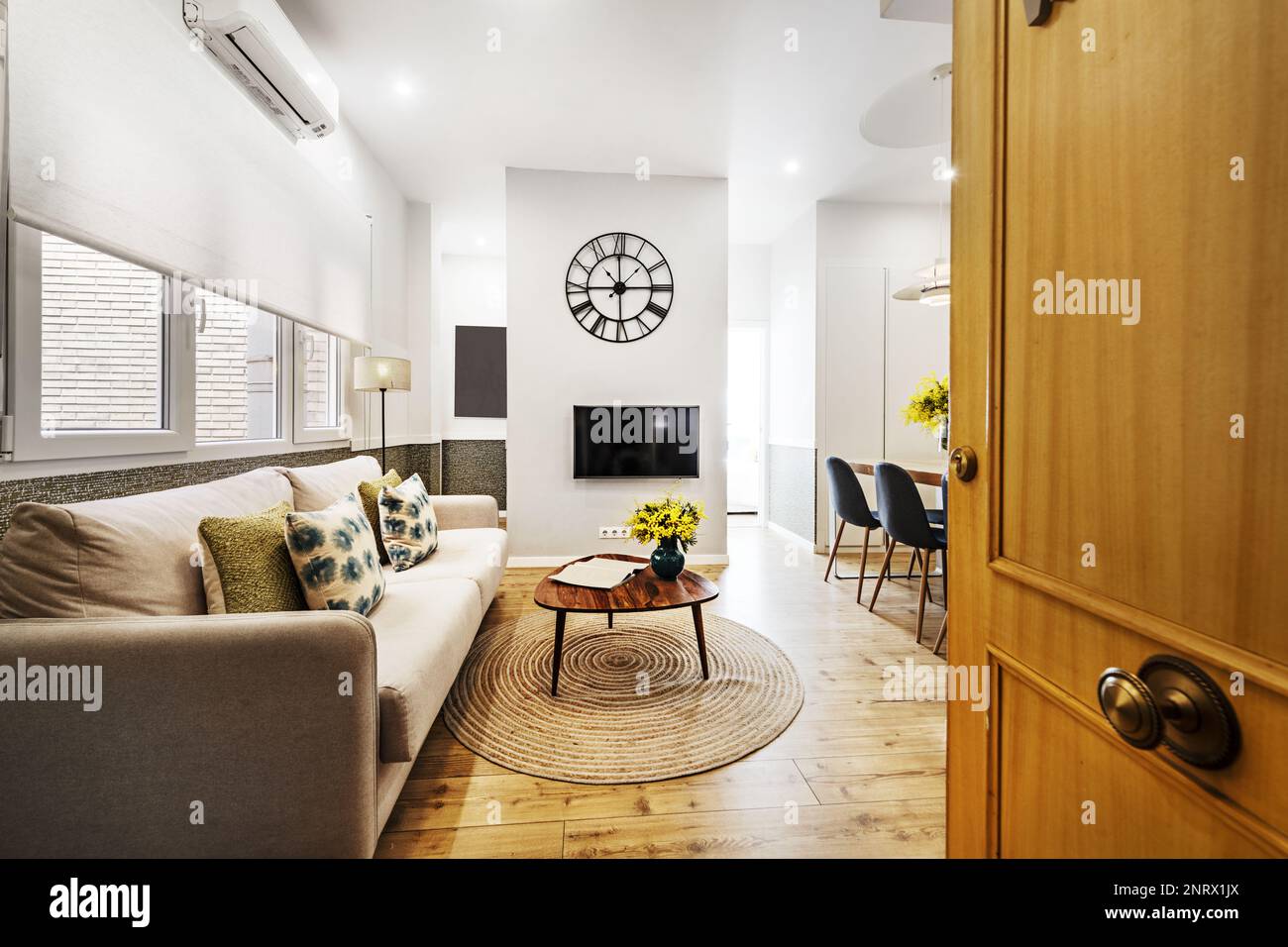 Access door to a house with chestnut flooring with a circular natural ...
