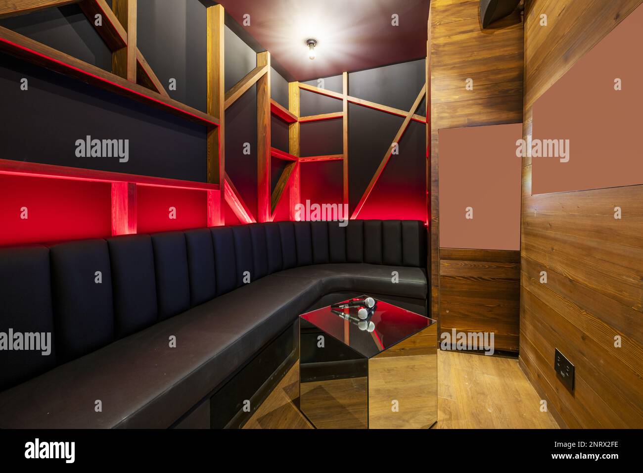 Empty karaoke room with perimeter sofa and wooden decoration with a ...