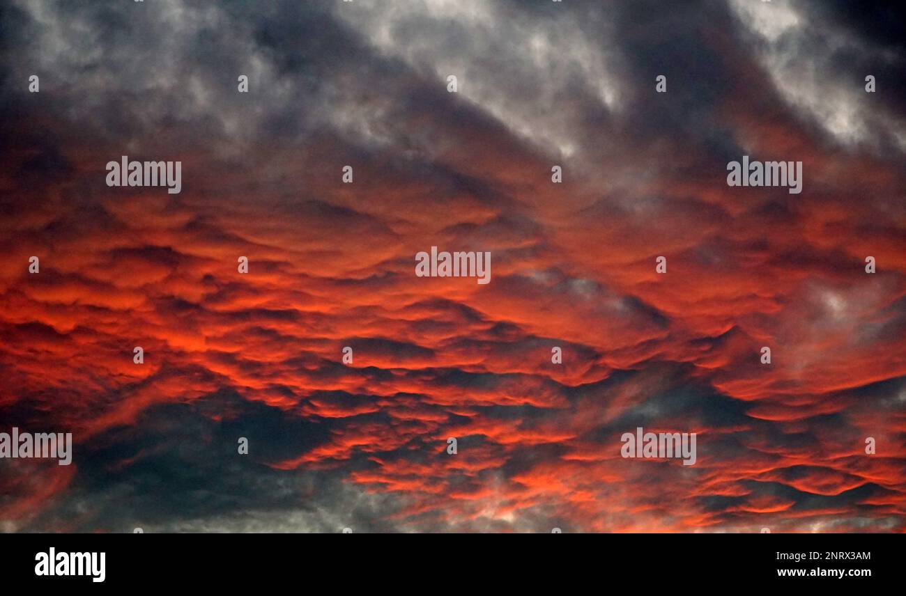 Sunset landscape with dark red clouds Stock Photo - Alamy