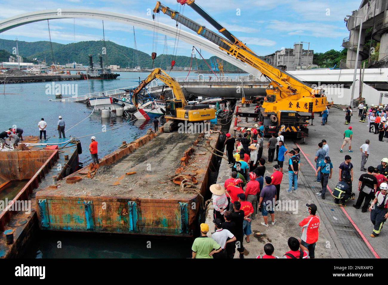 People watch a collapsed bridge in Nanfangao, eastern Taiwan. Tuesday ...