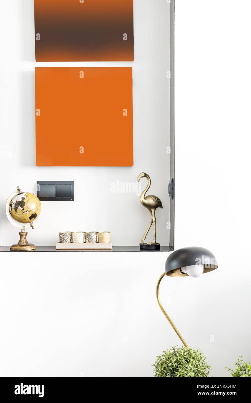 Corner of a room with a used niche with shelves with decorative objects ...