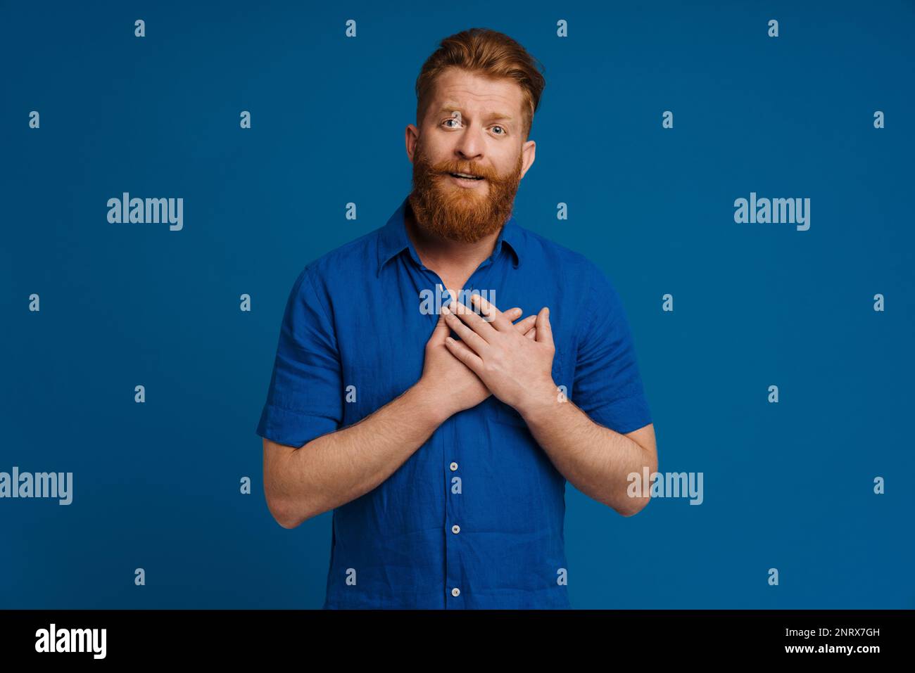Adult handsome redhead bearded man with folded hands on chest ...