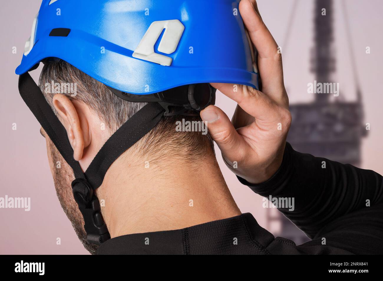 Man, tower worker. Work at height. Radio antenna. He puts on a helmet ...
