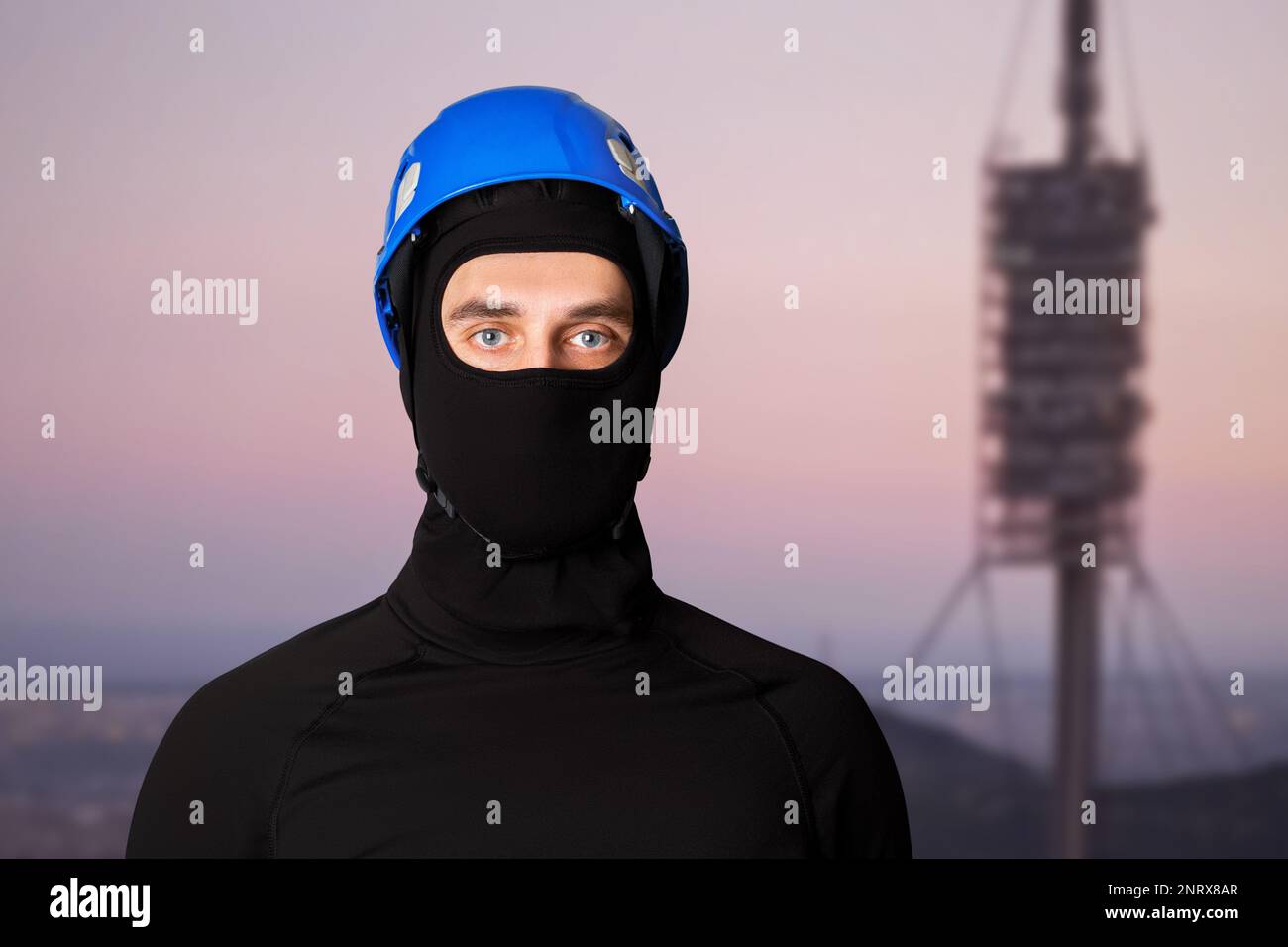 Man, tower worker. Work at height. Radio antenna. In a helmet ...