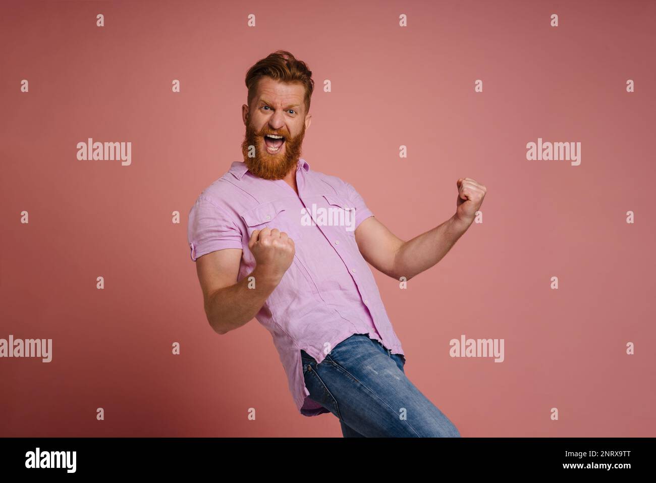 Ginger white man with beard screaming and winner gesture isolated over ...