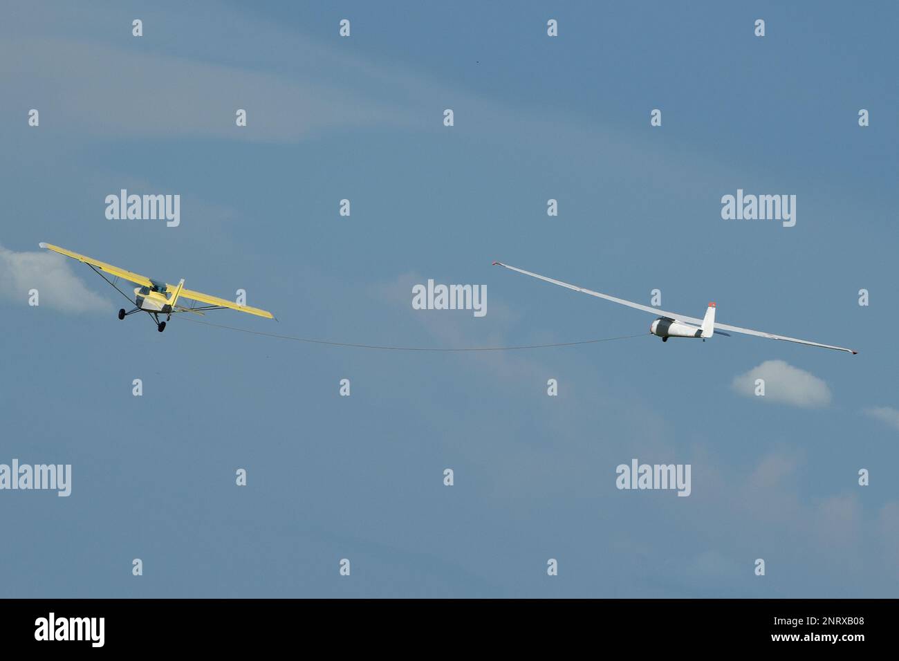 Aircraft tows a glider on a blue sky background. Back view. Brazil ...