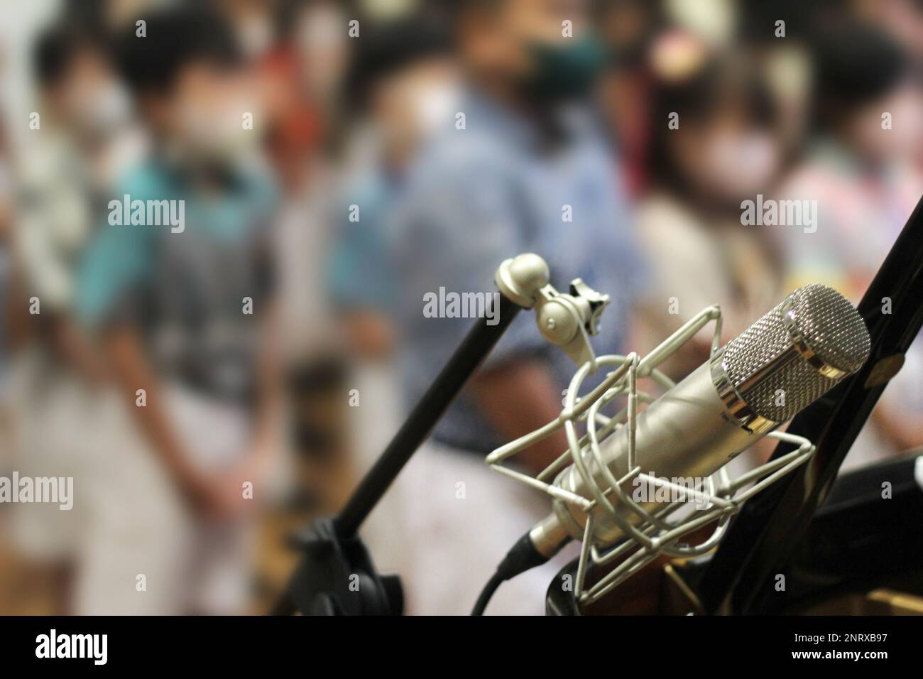 Live performance recording mic with children's background blur Stock ...
