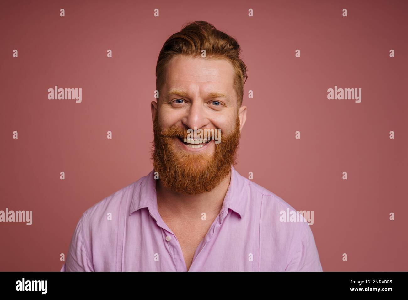 Ginger white man with beard smiling and looking at camera isolated over ...