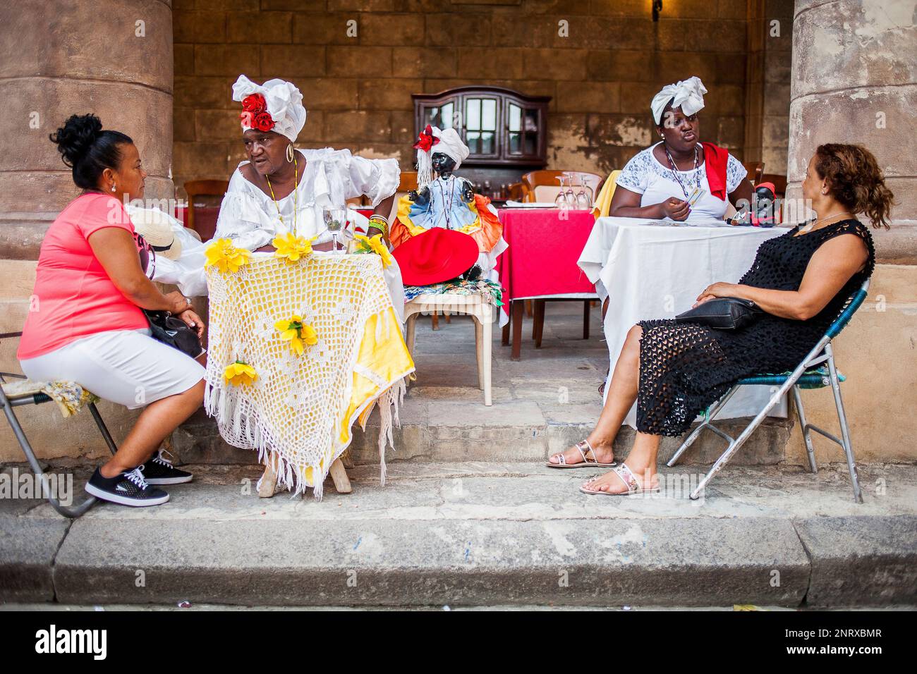 Cuban priestesses of the Afro-Cuban Santeria religion telling the ...