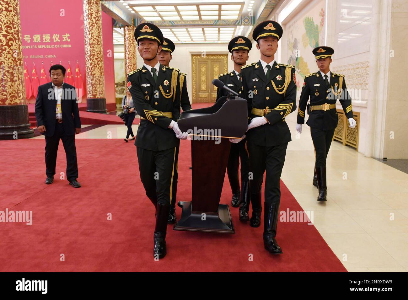 Chinese soldiers carry a podium before an award ceremony in Beijing's ...