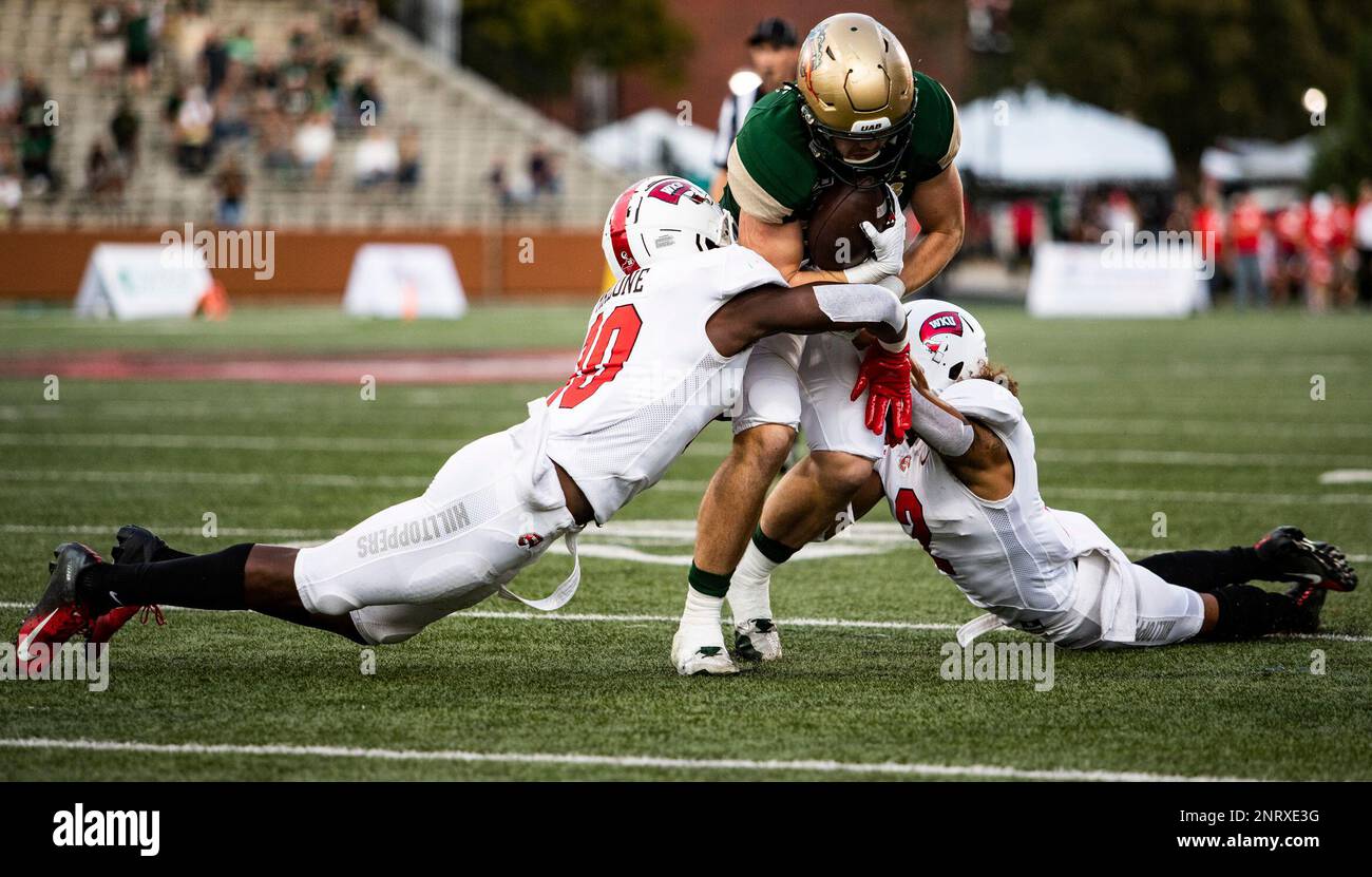 UAB tight end Gerrit Prince (20) is tackled by Western Kentucky ...