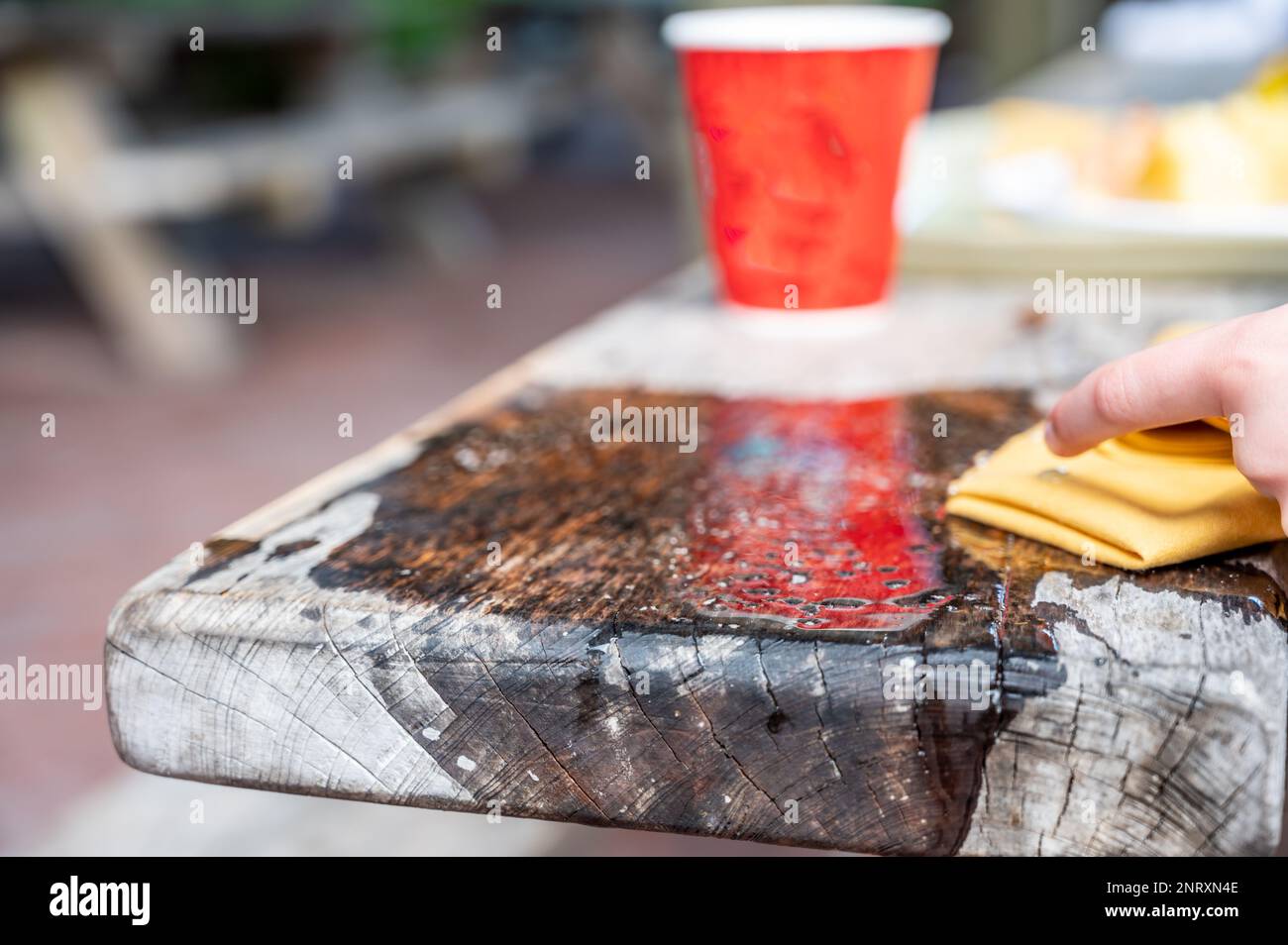 Spilled drink on a wooden picnic bench Stock Photo - Alamy