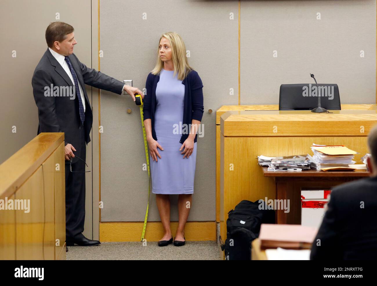 Defense attorney Toby Shook measures the height of a keyhole as fired ...