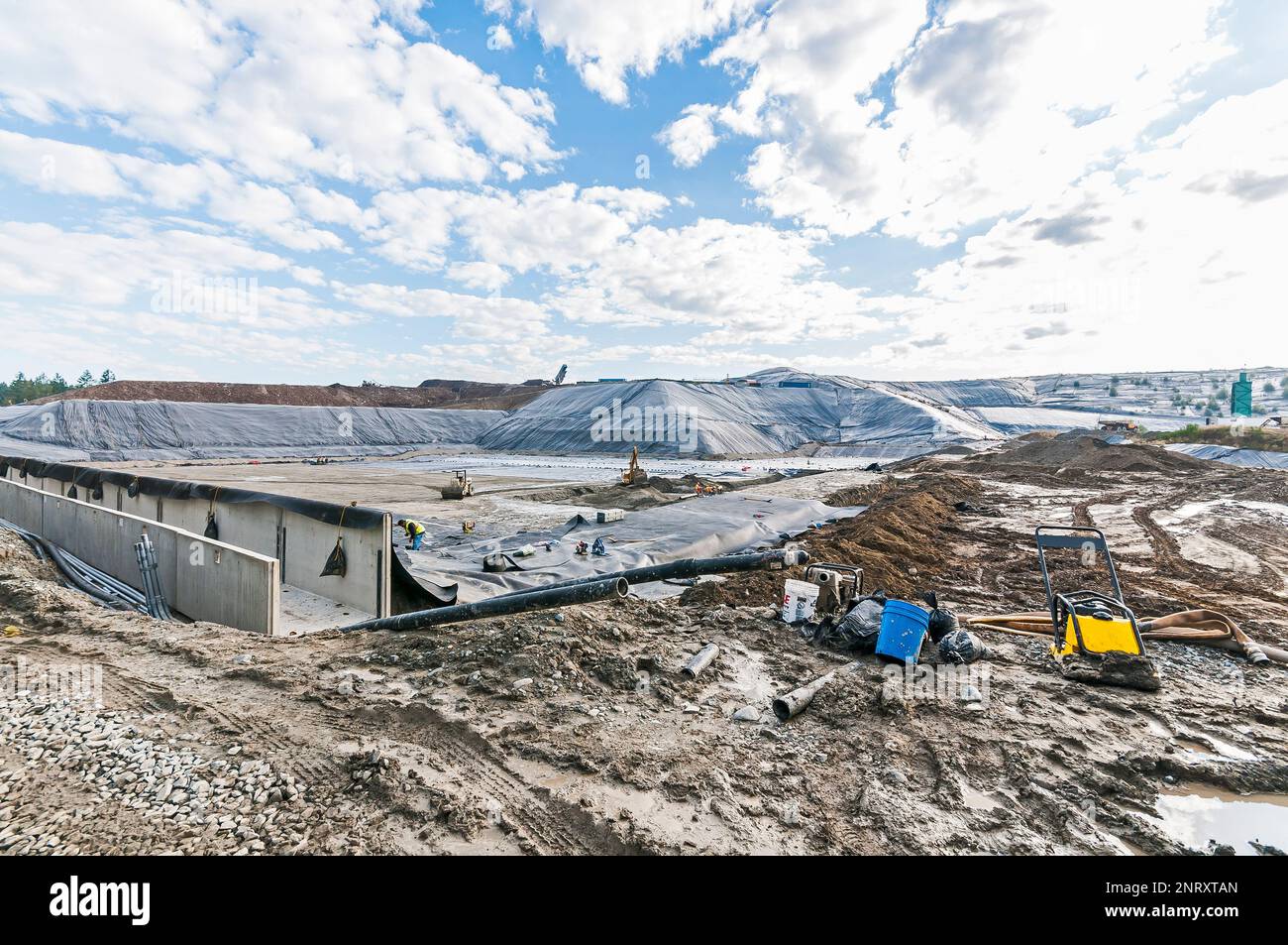 A concrete box culvert with a geomembrane covering and stabilizing ...