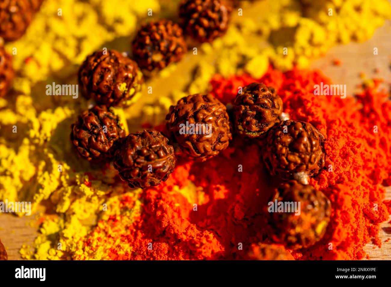 Colorful traditional holi powder on the table with wooden prayers ...