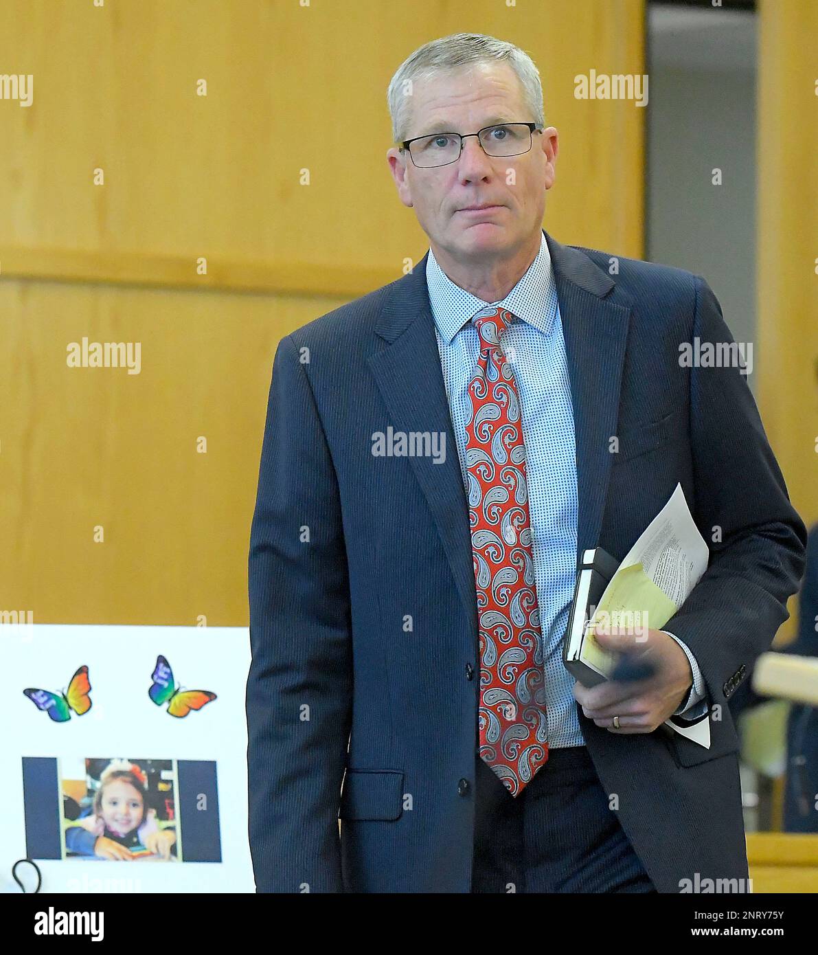 Prosecuting Attorney James Swink walks past a photo of Elizabeth "Lizzy ...