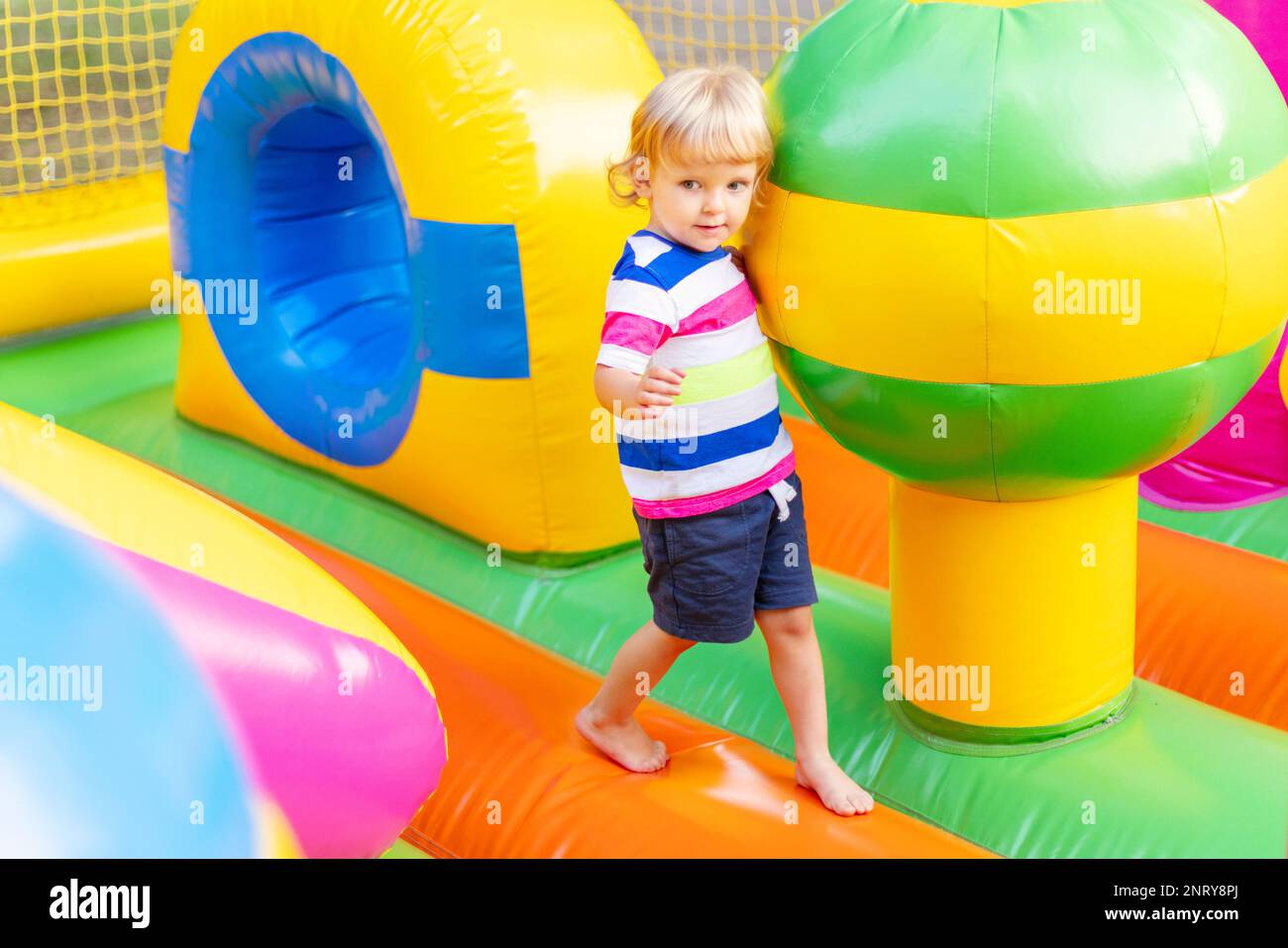 Happy kids having fun on colorful inflatable attraction playground ...