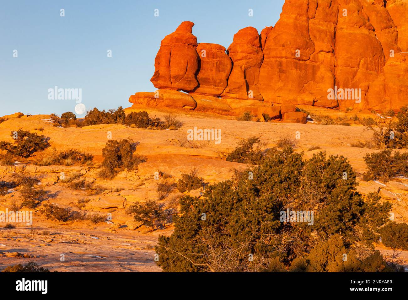 Setting moon by the Entrada sandstone formations of the Navajo Rocks ...