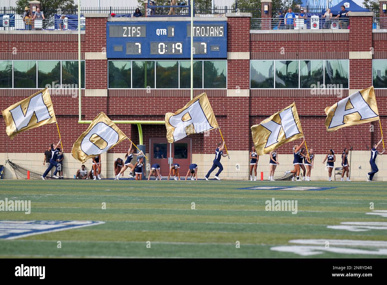 AKRON, OH - SEPTEMBER 21: Akron Zips cheerleaders run the Akron flags ...