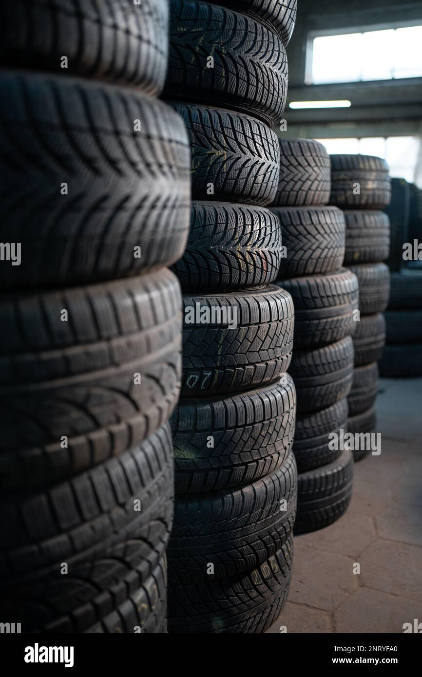 stack of car wheel tires at modern warehouse Stock Photo - Alamy