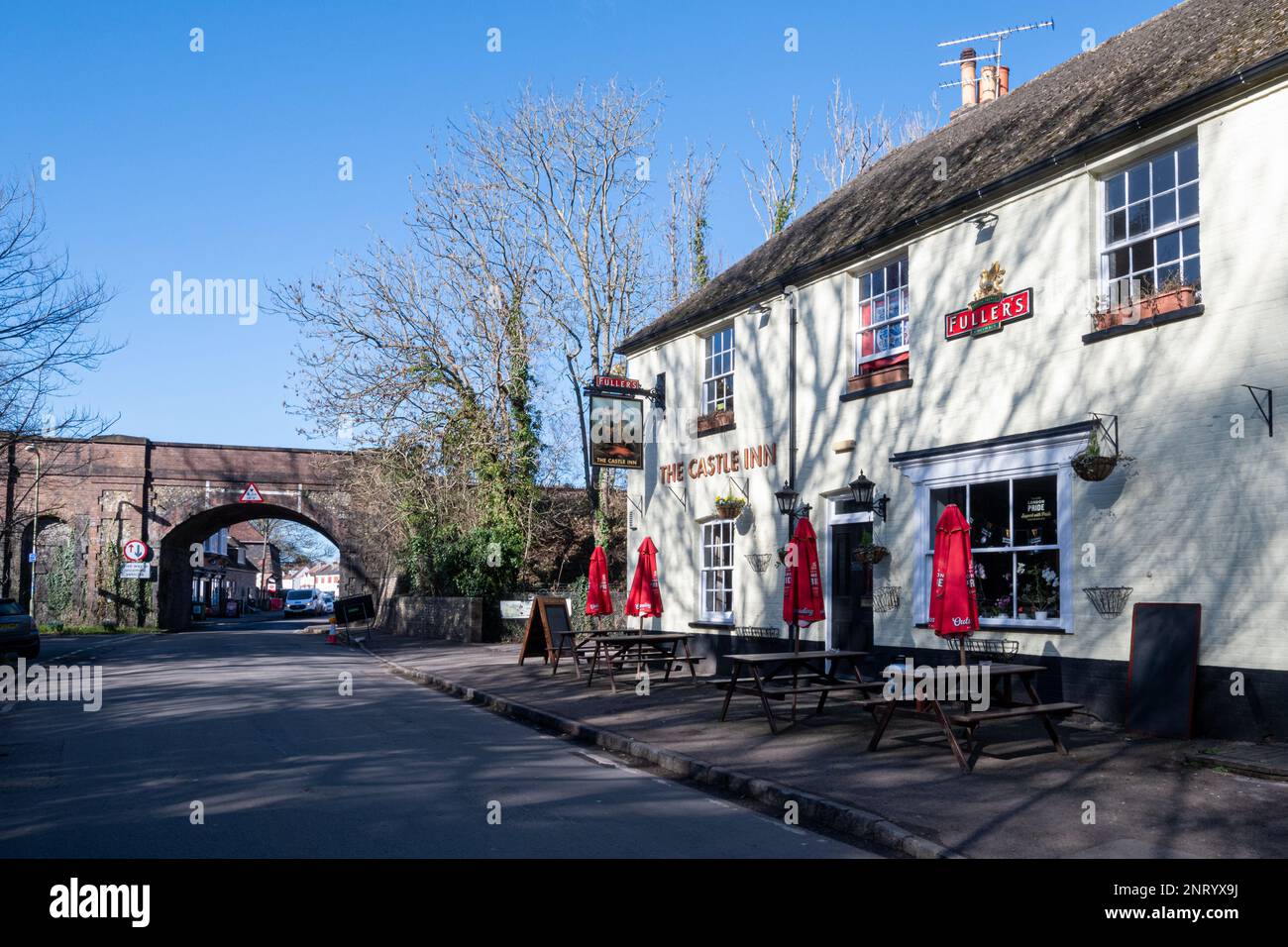 The Castle Inn pub and the railway bridge in Rowlands Castle village ...