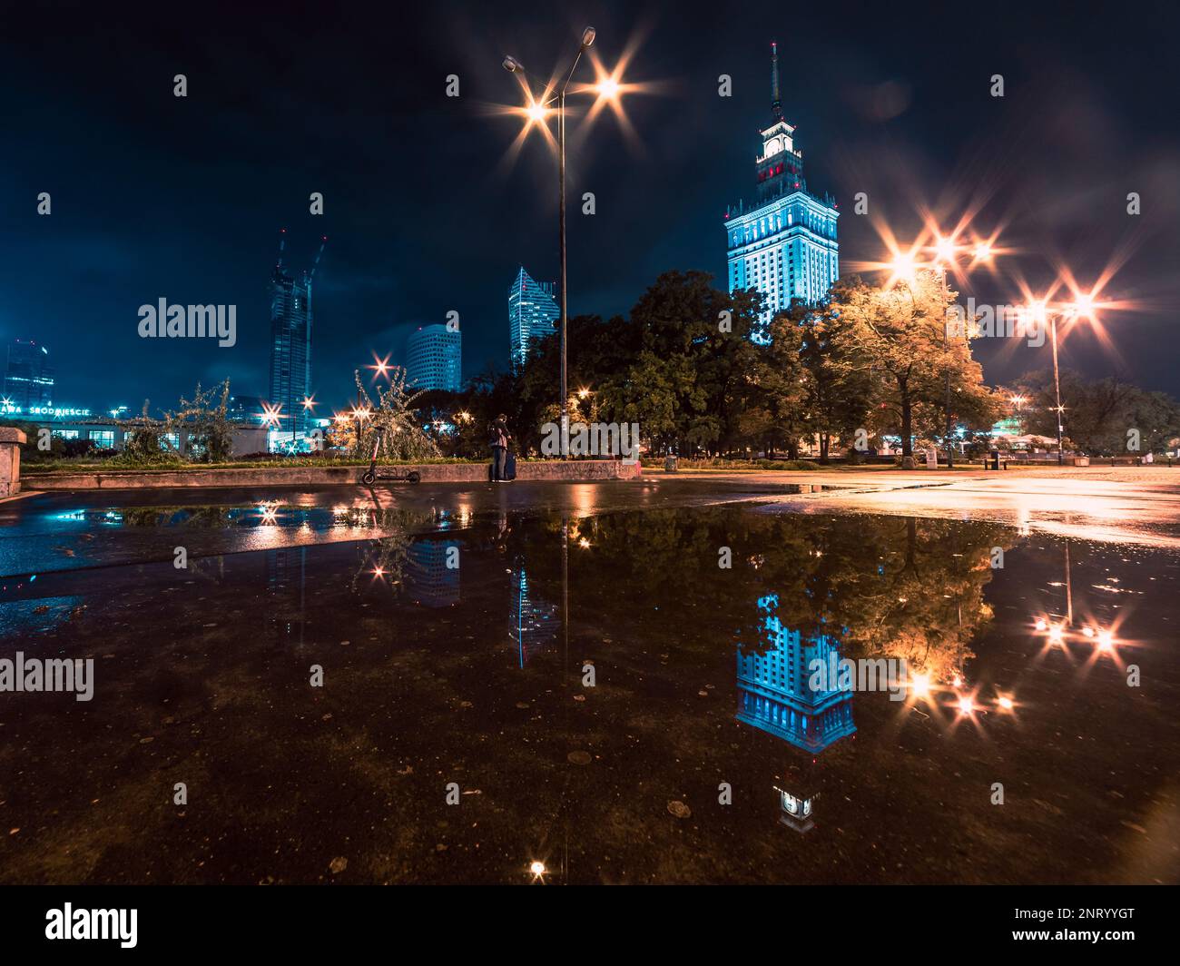 night cityscape with reflections in the puddle Stock Photo - Alamy