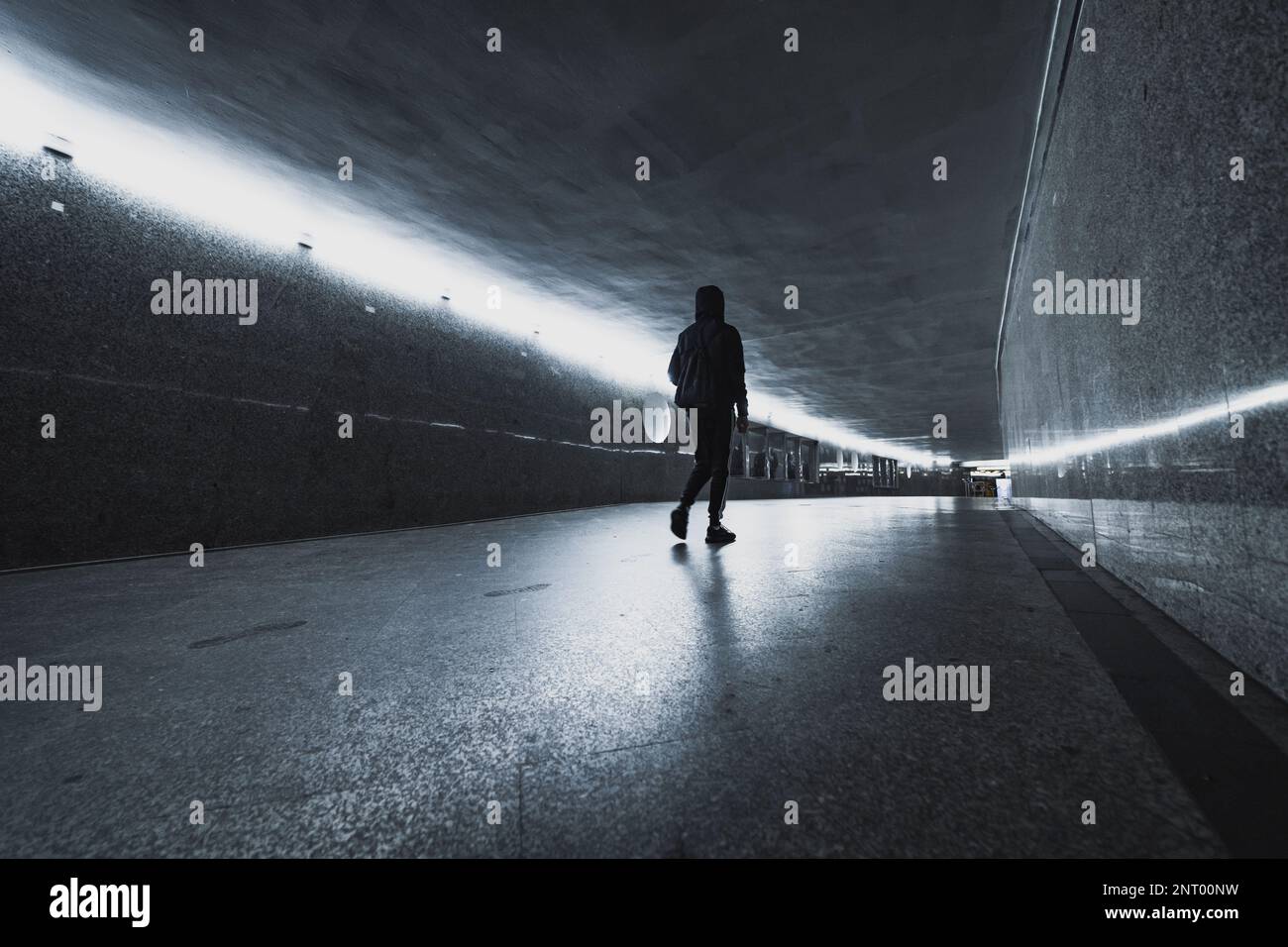 person in black clothes in underground passage Stock Photo - Alamy