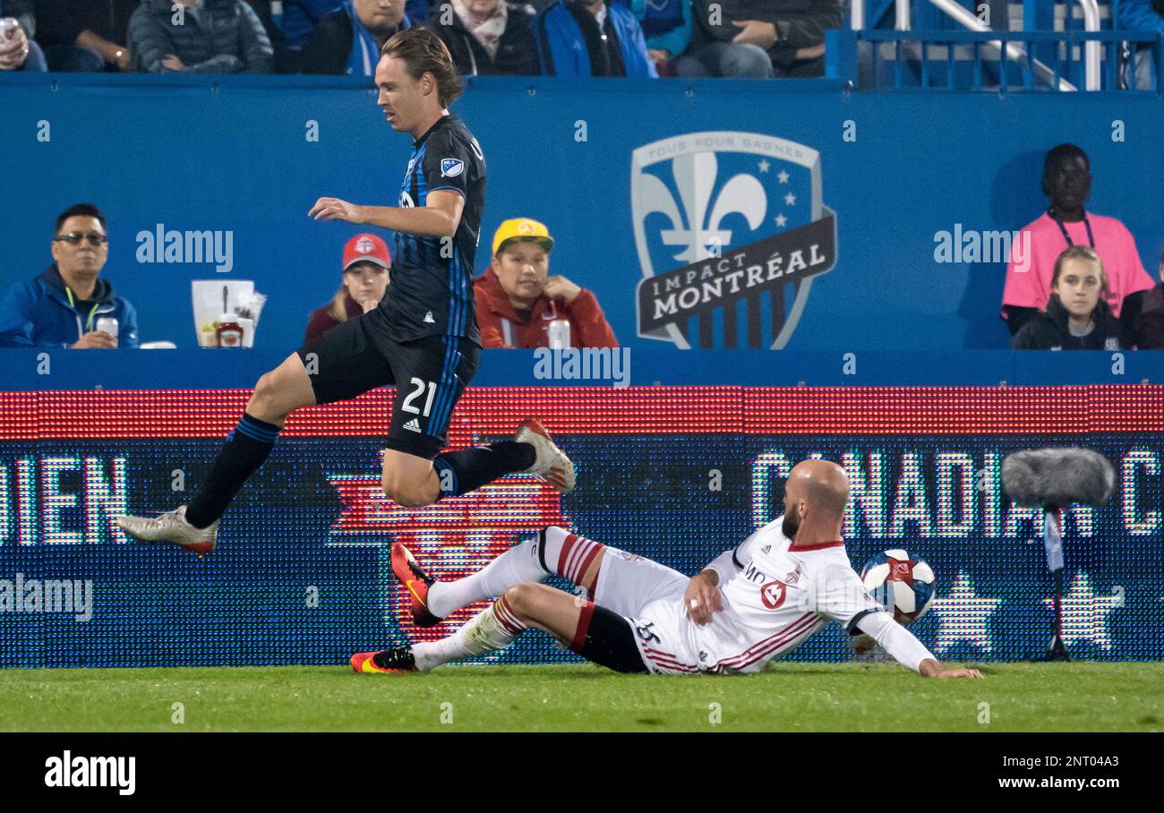 Montreal Impact's Lassi Lappalainen (21) leaps over Toronto FC defender ...