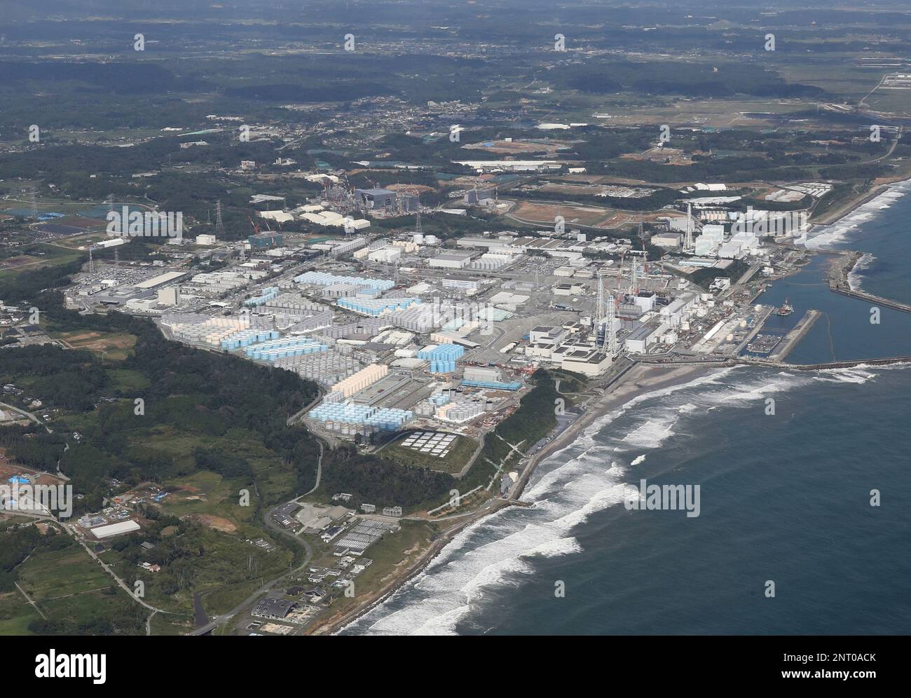 An aerial photo shows the tanks of contaminated water at the Fukushima ...
