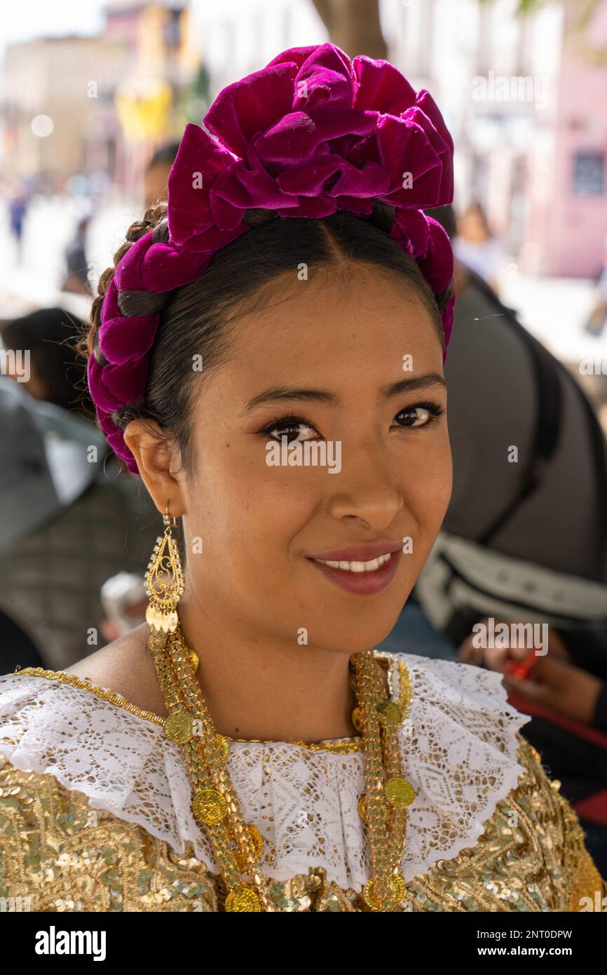 A young woman dressed in the traditional formal dress of a Tehuana, or ...