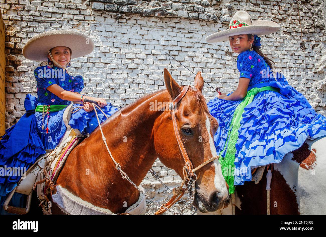 Escaramuzas ride their horses. A charreada Mexican rodeo at the Lienzo ...