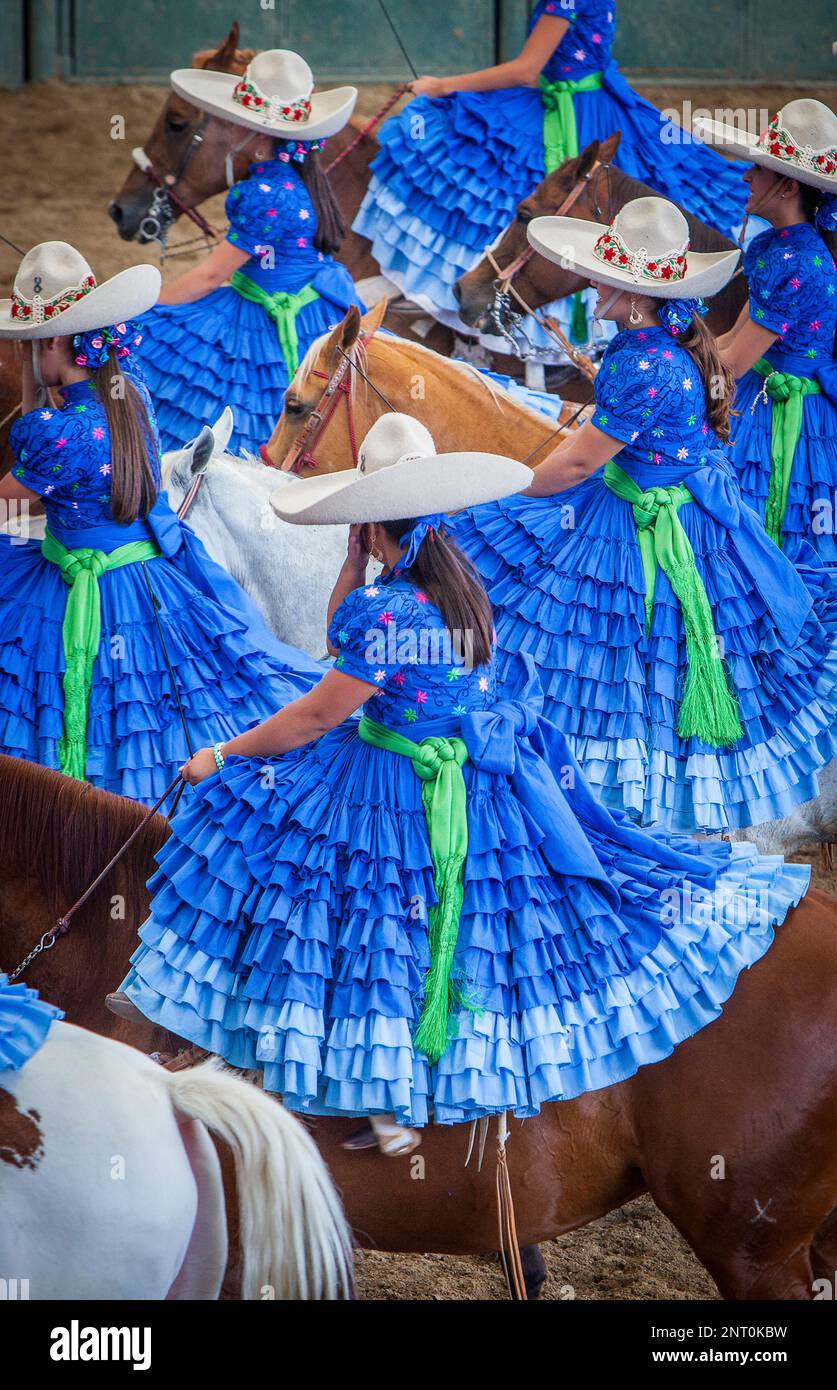 Escaramuzas ride their horses. A charreada Mexican rodeo at the Lienzo ...