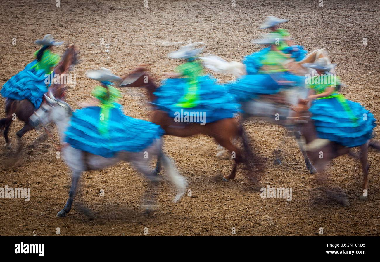Escaramuzas ride their horses. A charreada Mexican rodeo at the Lienzo ...
