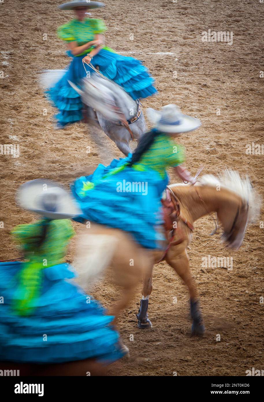 Escaramuzas ride their horses. A charreada Mexican rodeo at the Lienzo ...