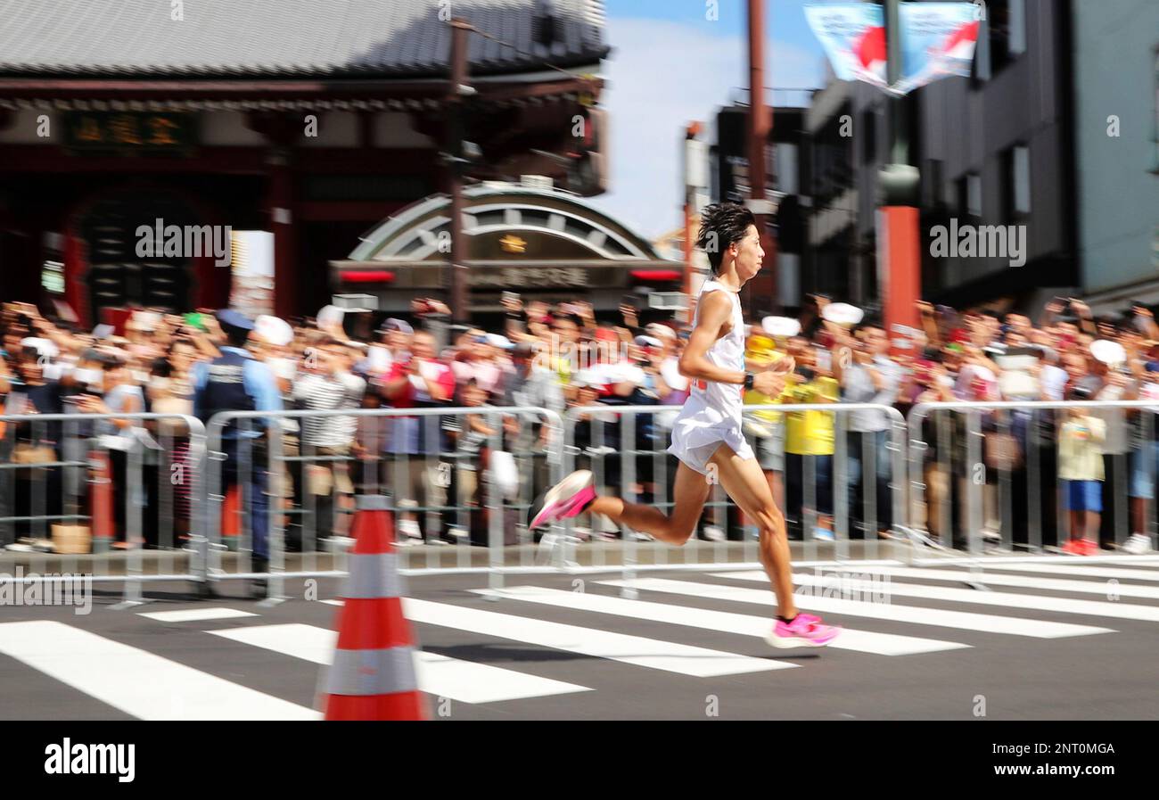 Runners compete during the Marathon Grand Championship in Asakusa ...
